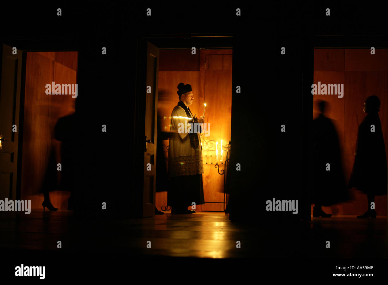 Priests carry candles dressed in 19th century clothing Stock Photo - Alamy