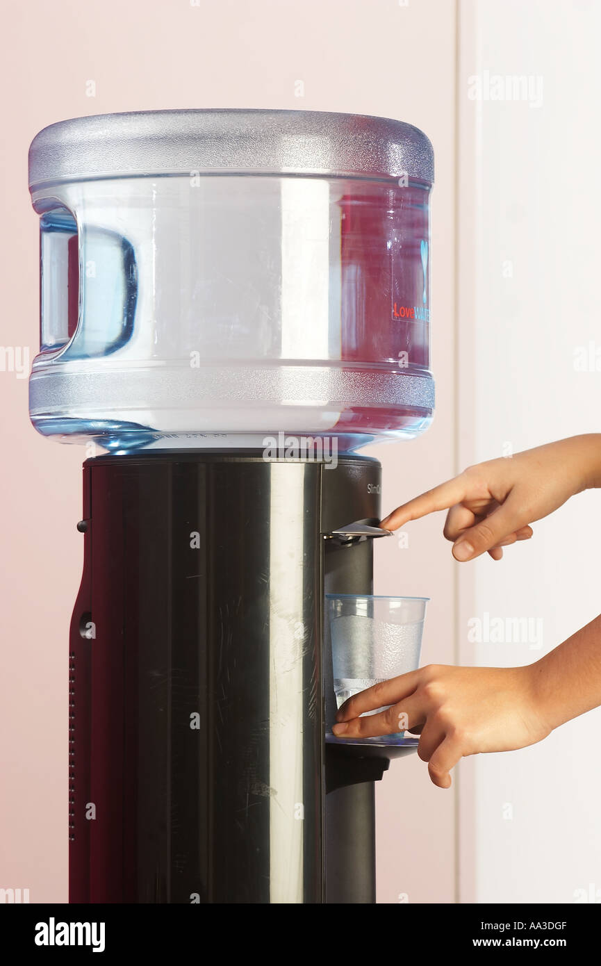 Child getting drink from a water cooler in the kitchen Stock Photo - Alamy