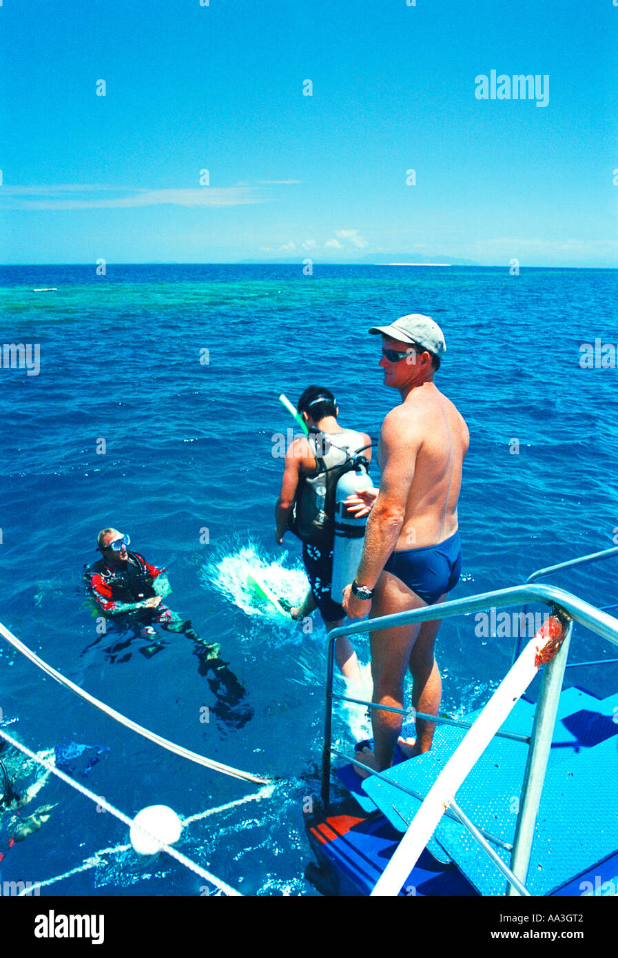 Divers of a day trip from Cairns enter the waters of Paradise Reef on ...