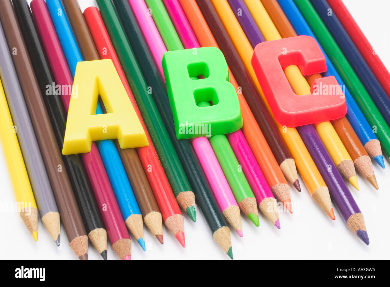 Colour Pencils and Plastic Alphabets Stock Photo - Alamy