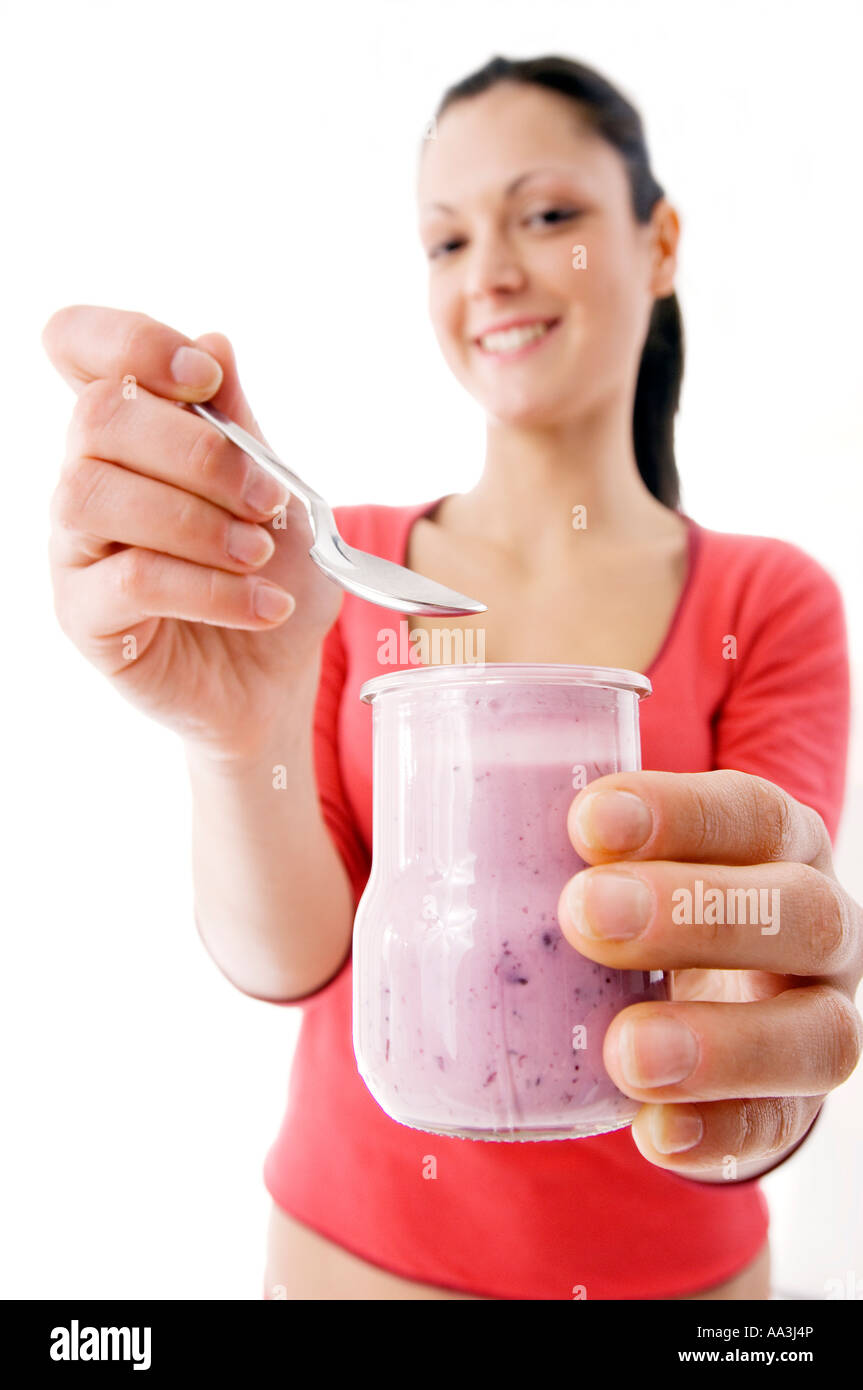 young woman eating yogurt Stock Photo - Alamy