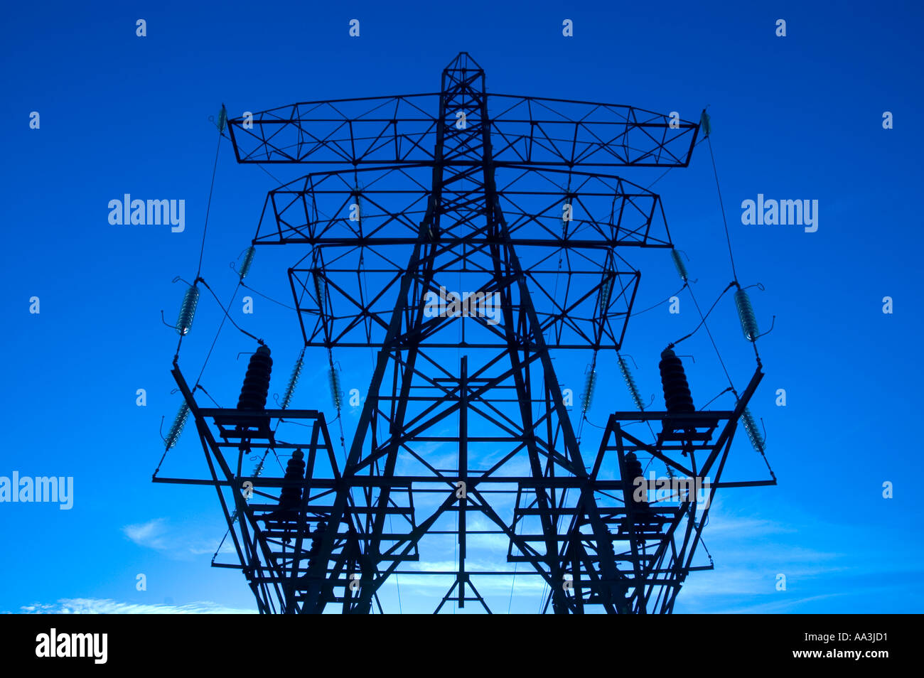 Sun setting behind electricity pylon Stock Photo - Alamy