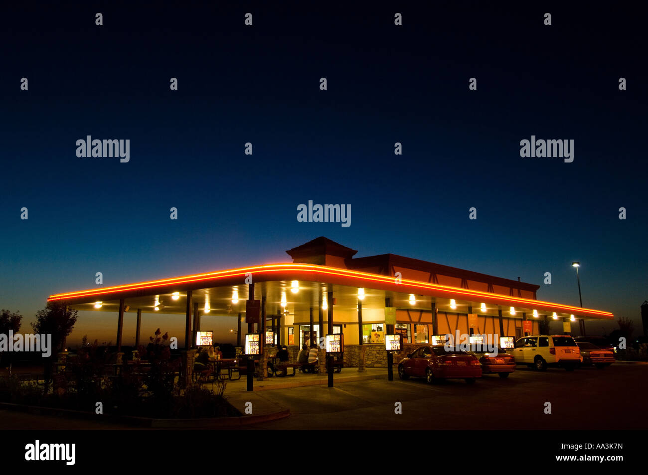 The sun sets over a typical American drive-through restaurant Stock ...