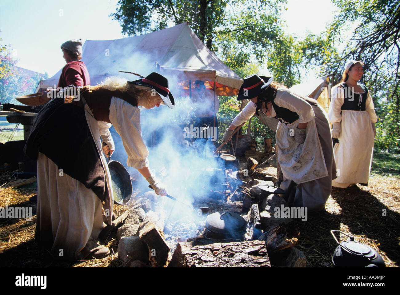 USA Maryland MR Women in period costume tend campfire at 17th Century ...