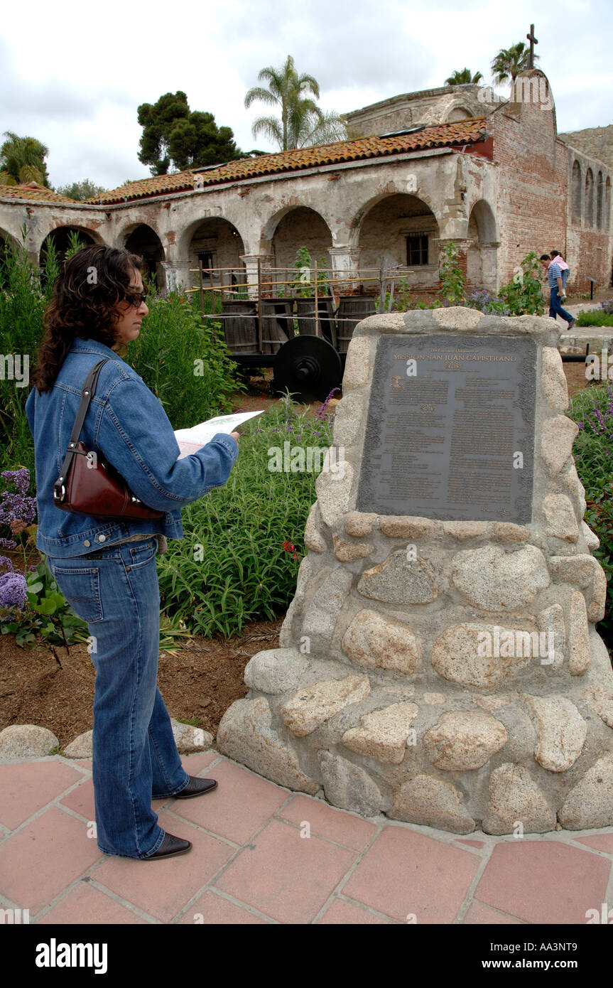 Tourist woman standing next to the Founding Document, Mission San Juan ...