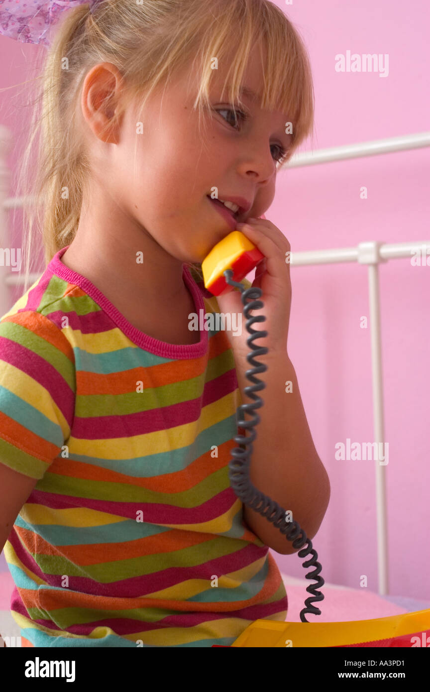 young blond girl in her bedroom playing by herself Stock Photo - Alamy