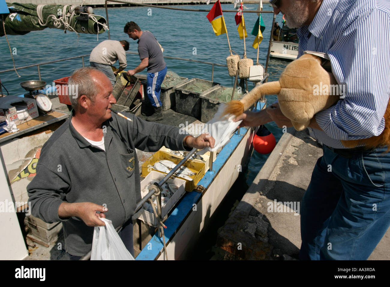 Customer buying fresh fish from a fisherman fresh fish being unloaded ...