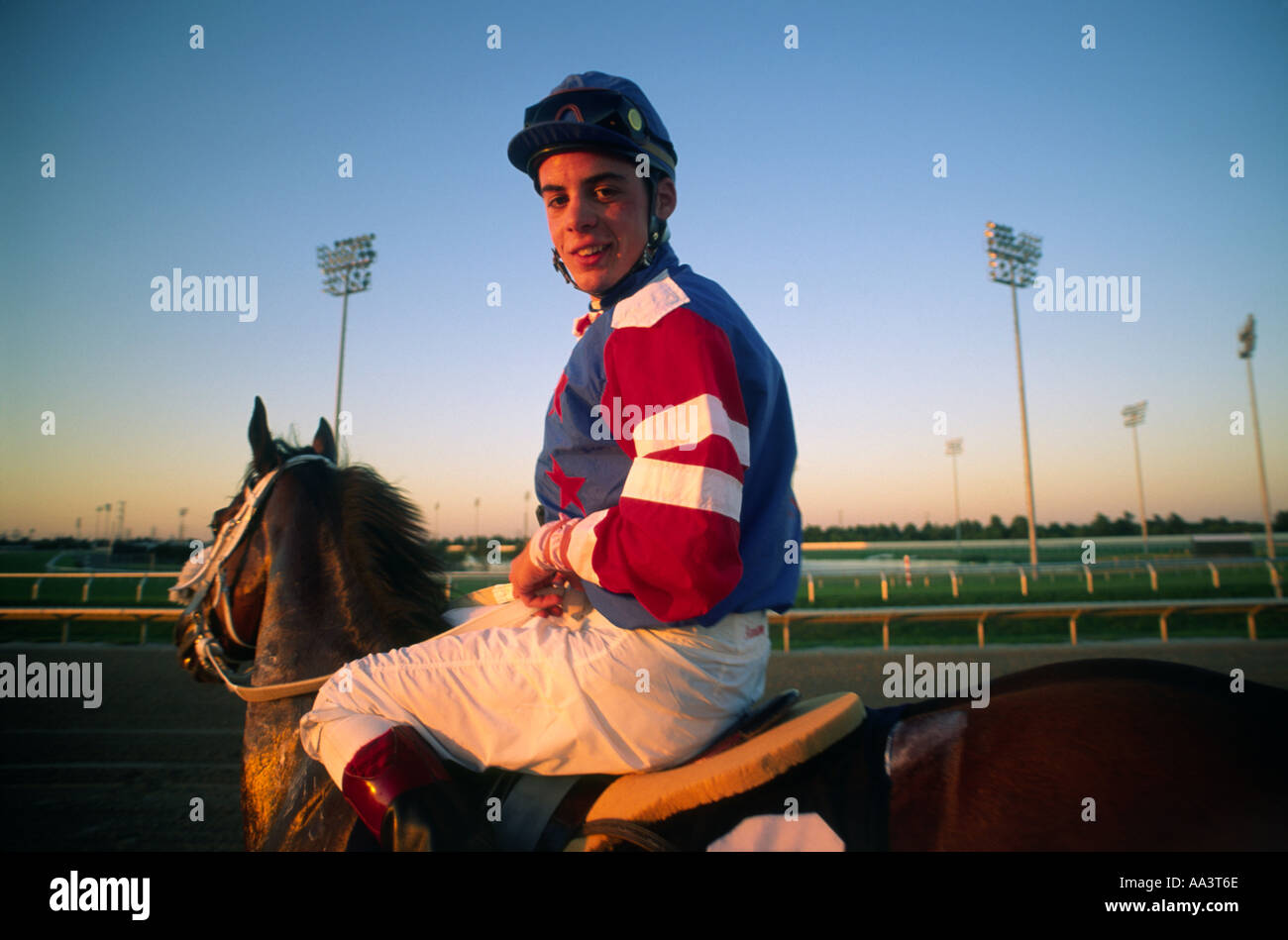 A jockey poses for the camera after a workout with a race horse Stock ...