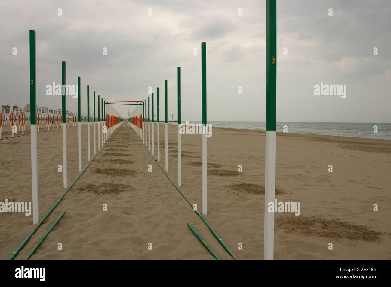 coloured poles standing in rows and disapearing into perspective on the ...