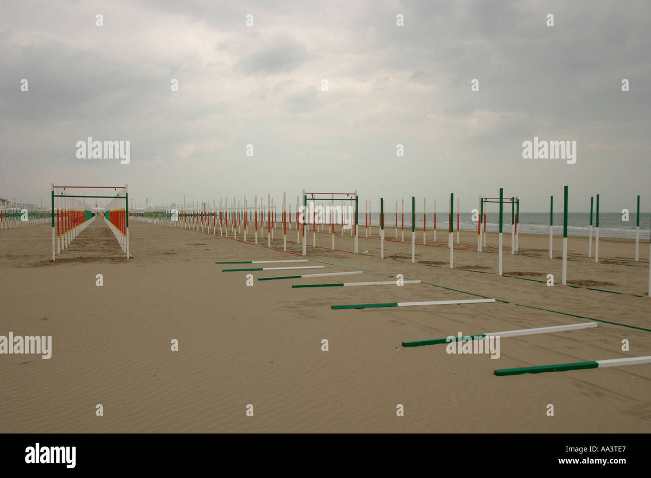 coloured poles standing in rows and disapearing into perspective on the ...