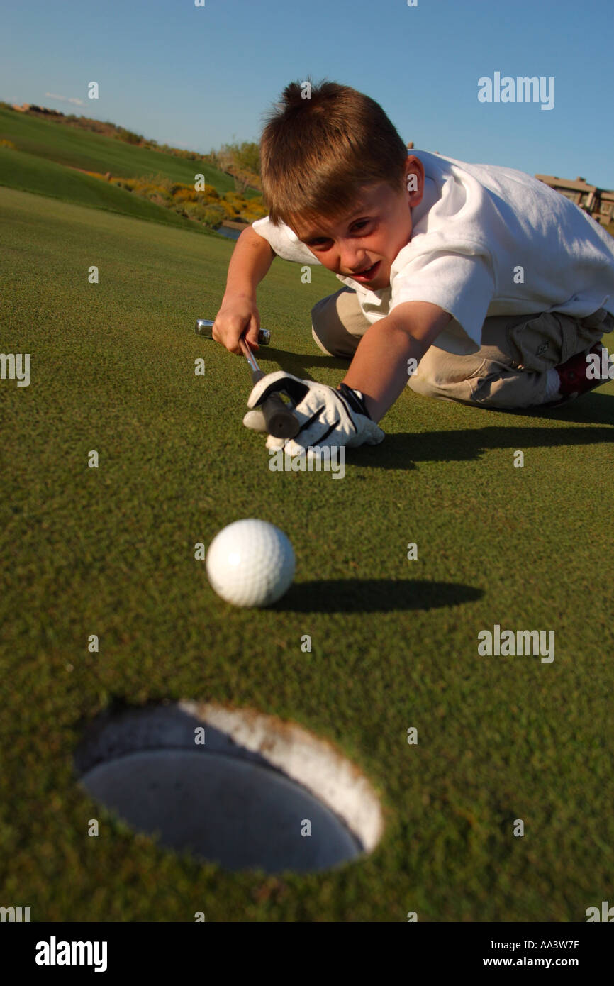Boy Playing on golf course Stock Photo - Alamy