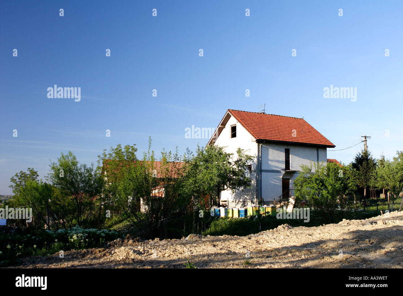 new built house in suburbs of Belgrade with bee hives in garden Serbia ...