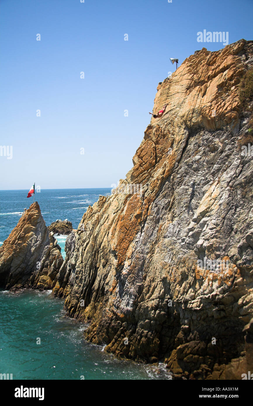 Cliff diver, a clavadista, diving off the cliffs at La Quebrada ...