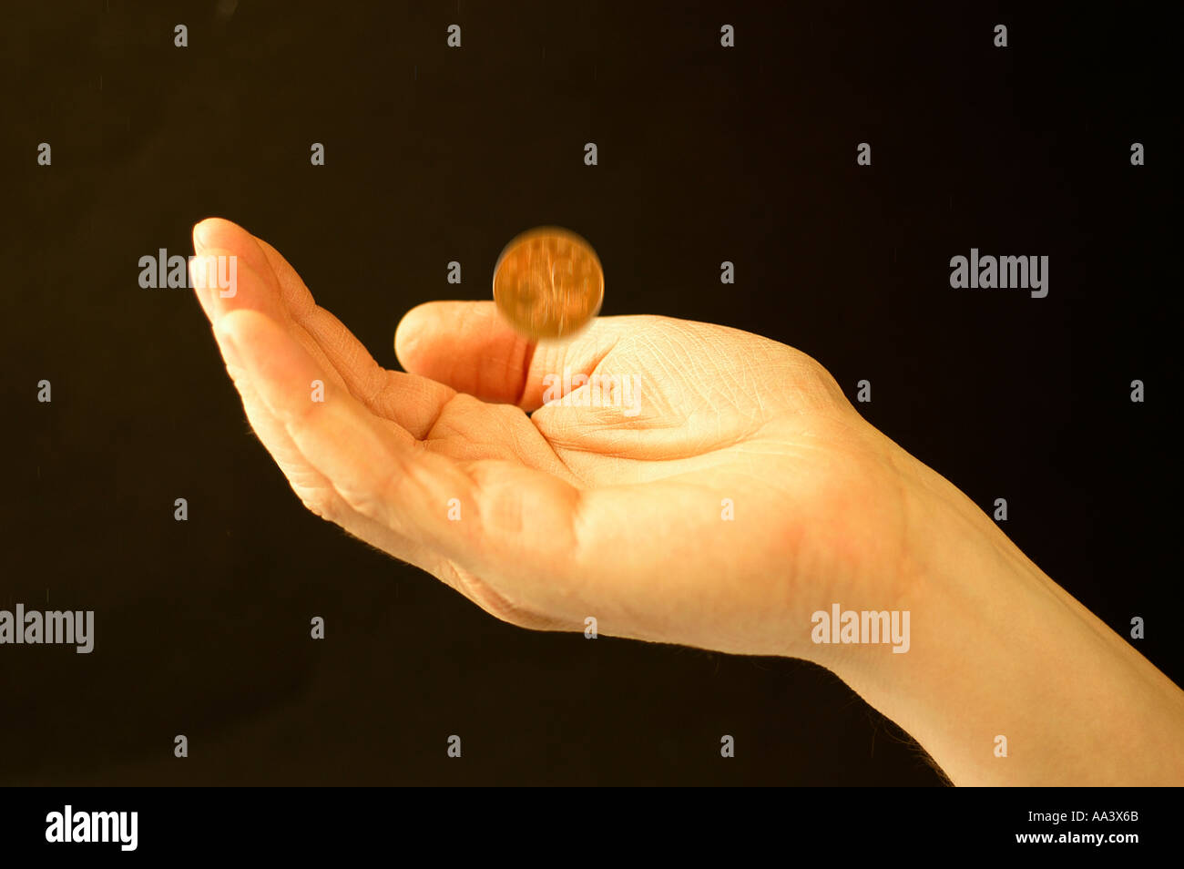 COIN FALLING INTO HAND Stock Photo - Alamy
