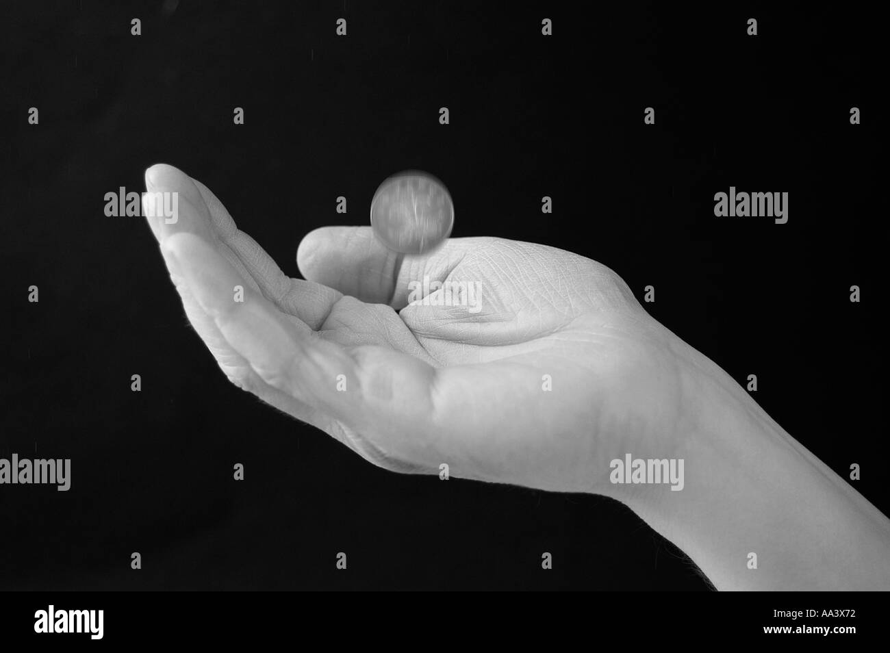 COIN FALLING INTO HAND Stock Photo - Alamy