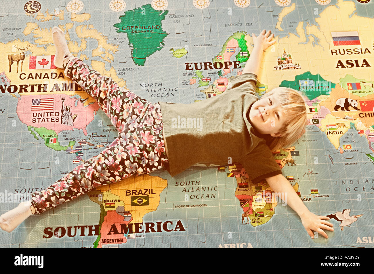3 year old female on puzzle map Stock Photo - Alamy