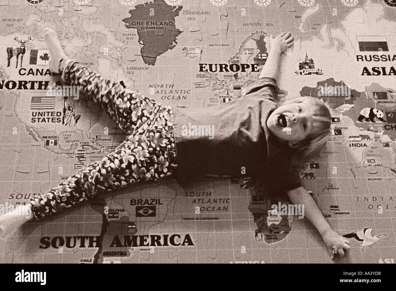 3 year old female on puzzle map Stock Photo - Alamy