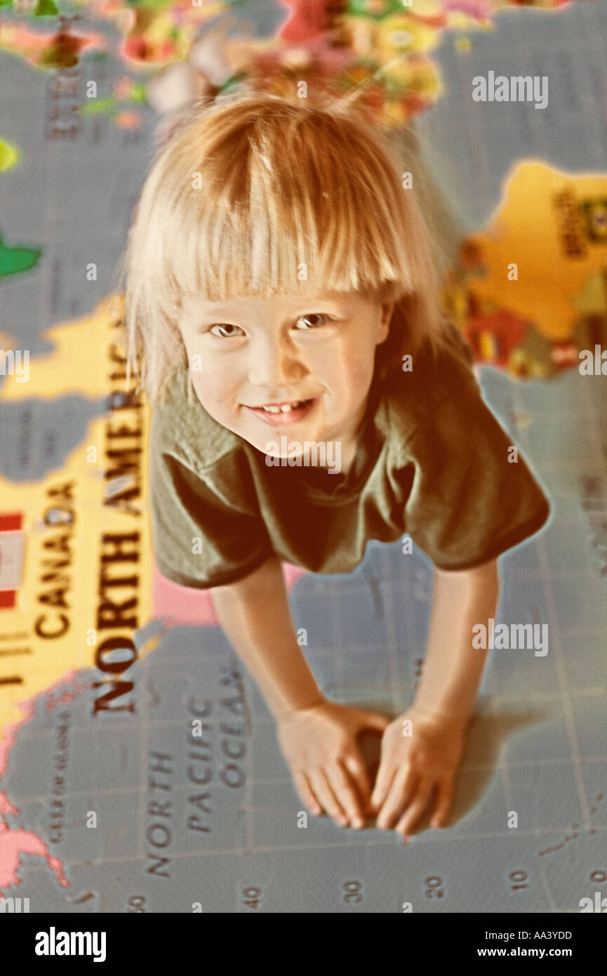 3 year old female on puzzle map Stock Photo - Alamy