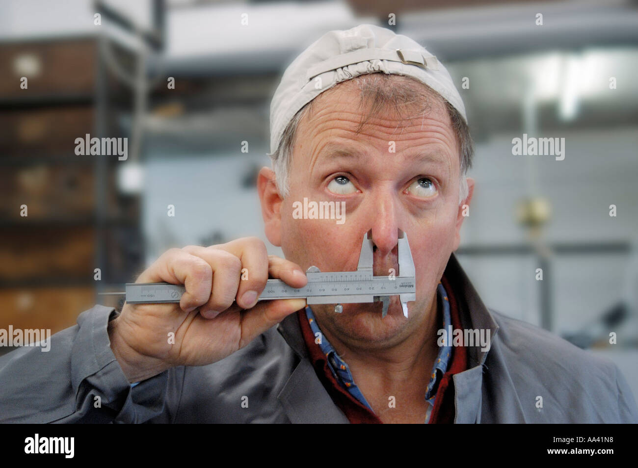 Craftsman is clamping his nose in sliding caliper calliper Stock Photo ...