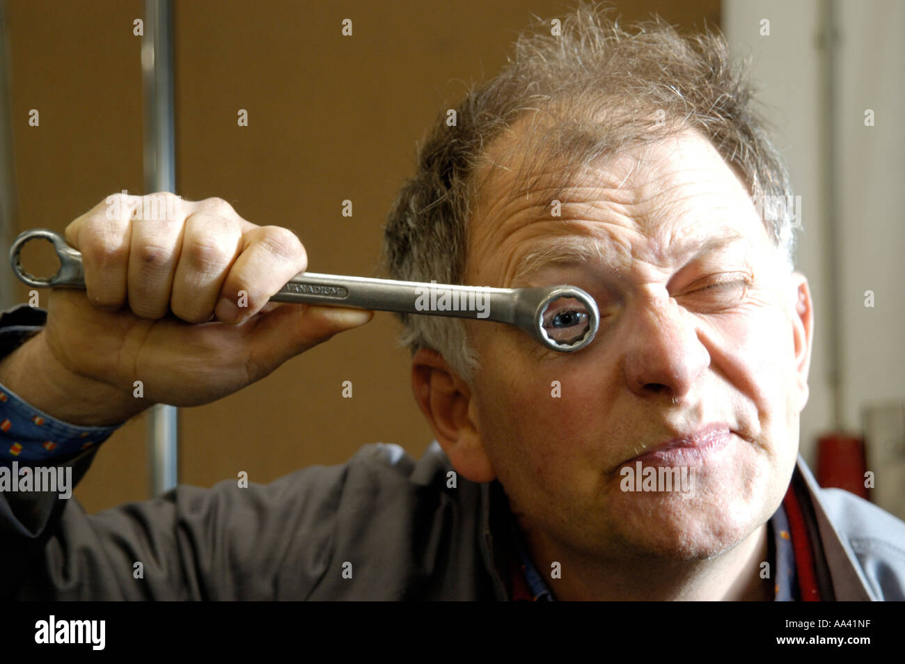 Craftsman is looking through a screw wrench Stock Photo - Alamy