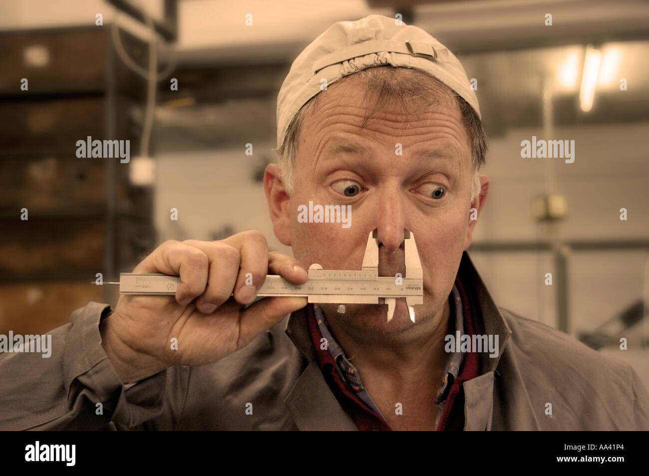 Craftsman is clamping his nose in sliding caliper calliper Stock Photo ...