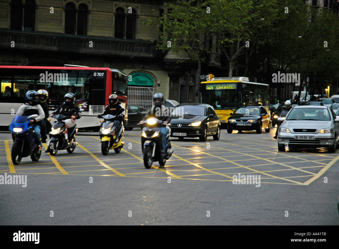Street traffic in the evening with motorcycles, street scene, Barcelona ...