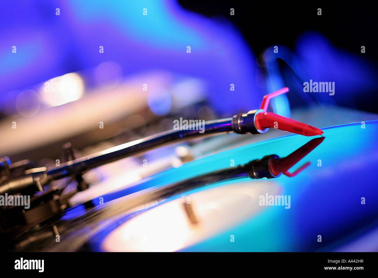 Close Up of a blue vinyl record on a turntable with red head spinning ...