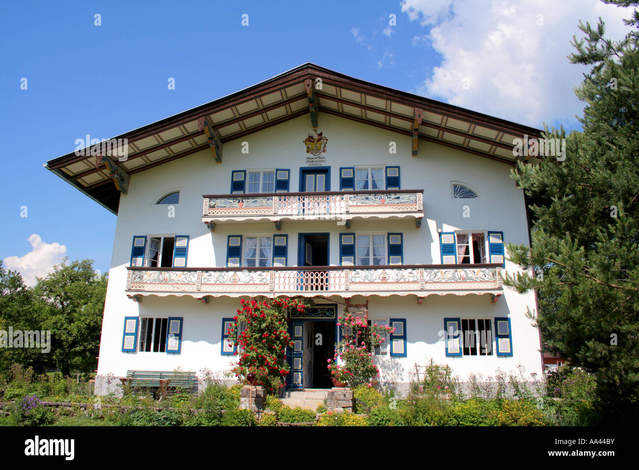 Traditional Bavarian farm house with wooden carved balcony and ...