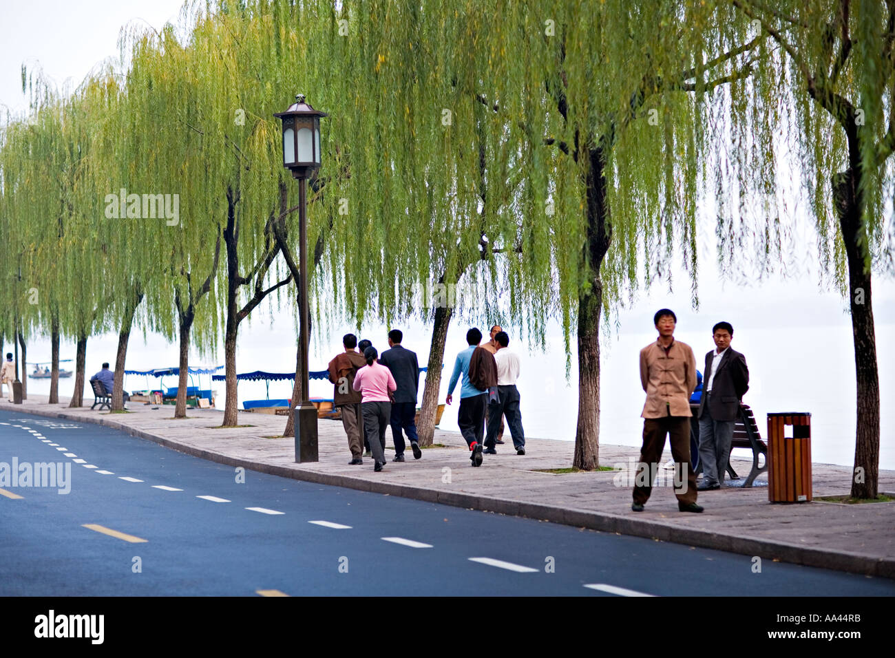 CHINA HANGZHOU Citizens of Hangzhou walking under willow trees on the ...