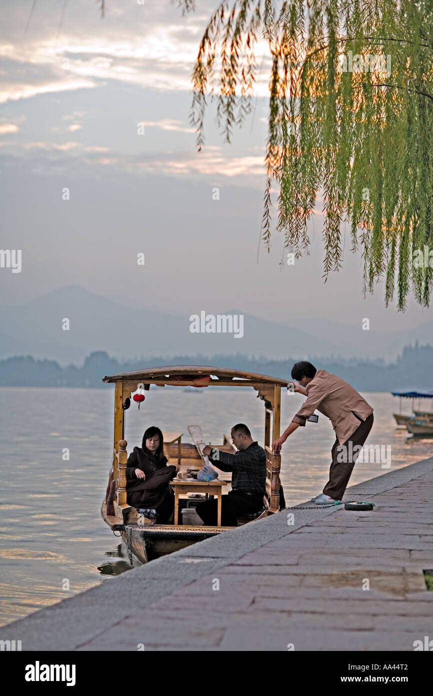 CHINA HANGZHOU Boatman pushes off his boat ready to serve tea from ...