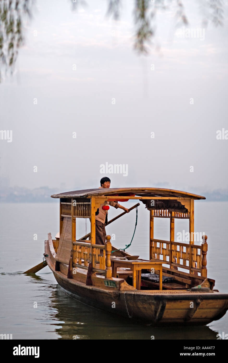 CHINA HANGZHOU Boatman trolls for customers in his boat ready to serve ...