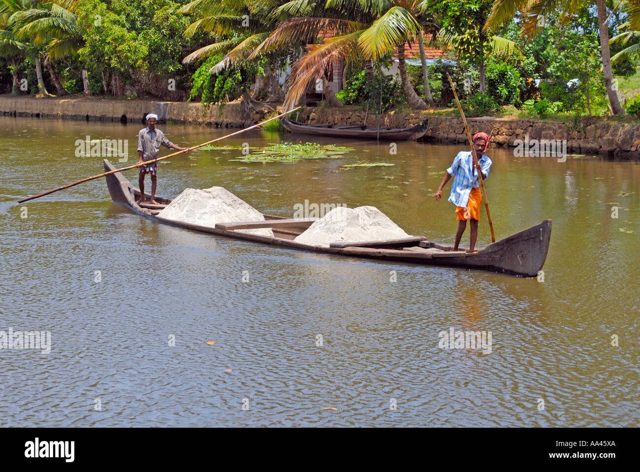 An overloaded boat with is cargo of sand on the Backwaters of Kerala ...