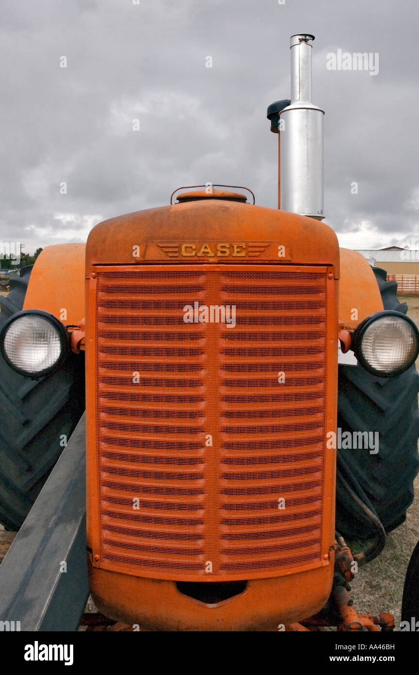 Vintage Case Tractor with belt on powering a vintage thresher. Front ...