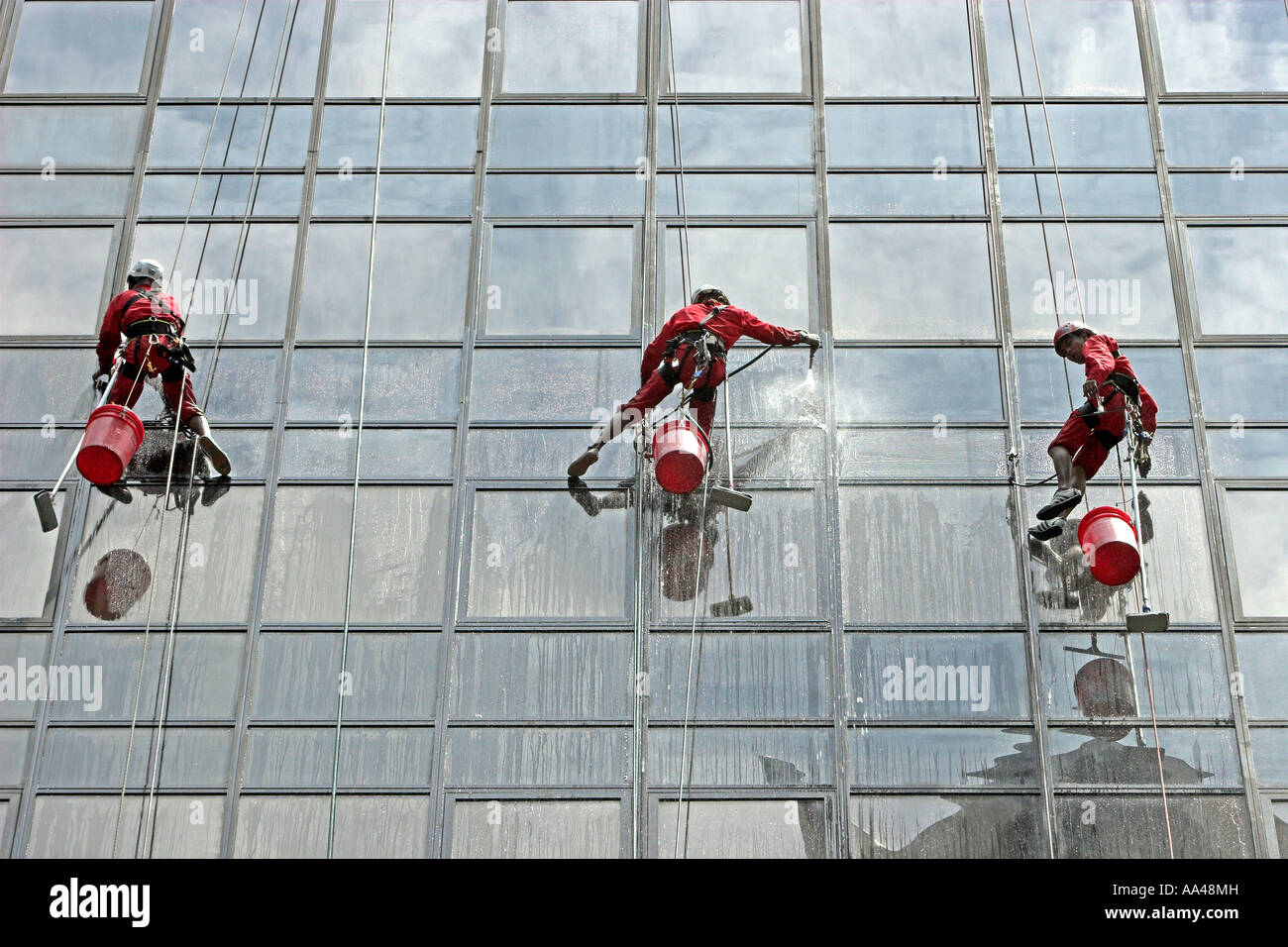 High rise window cleaners work suspended on ropes Orchard Road ...
