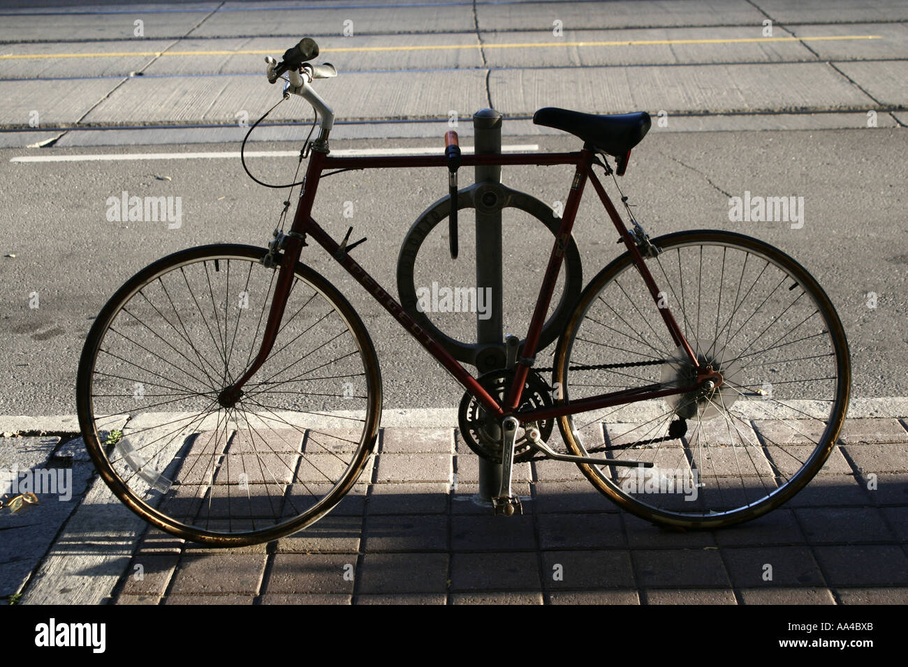Bicycle in silhouette parked on pavement Stock Photo - Alamy