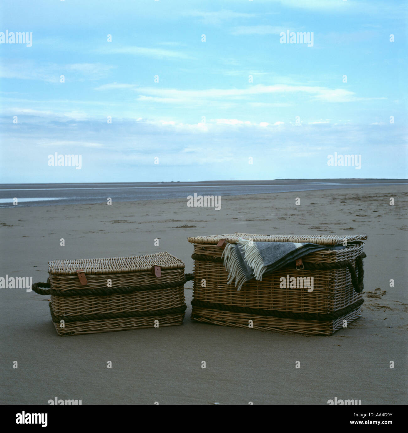 Wicker laundry chests on sandy beach Stock Photo - Alamy