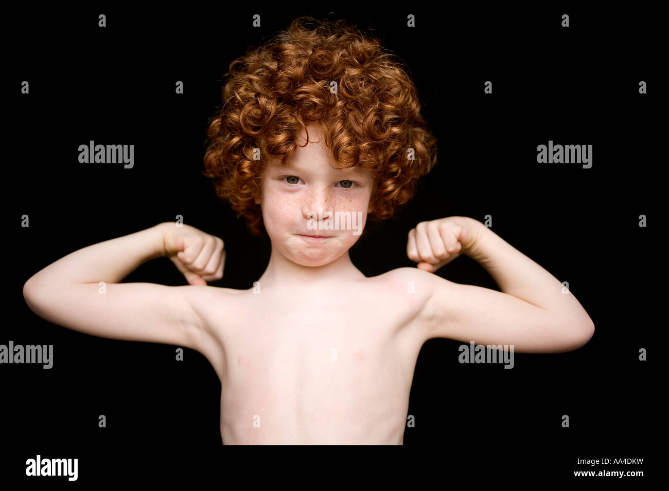 Young boy making muscles Stock Photo - Alamy