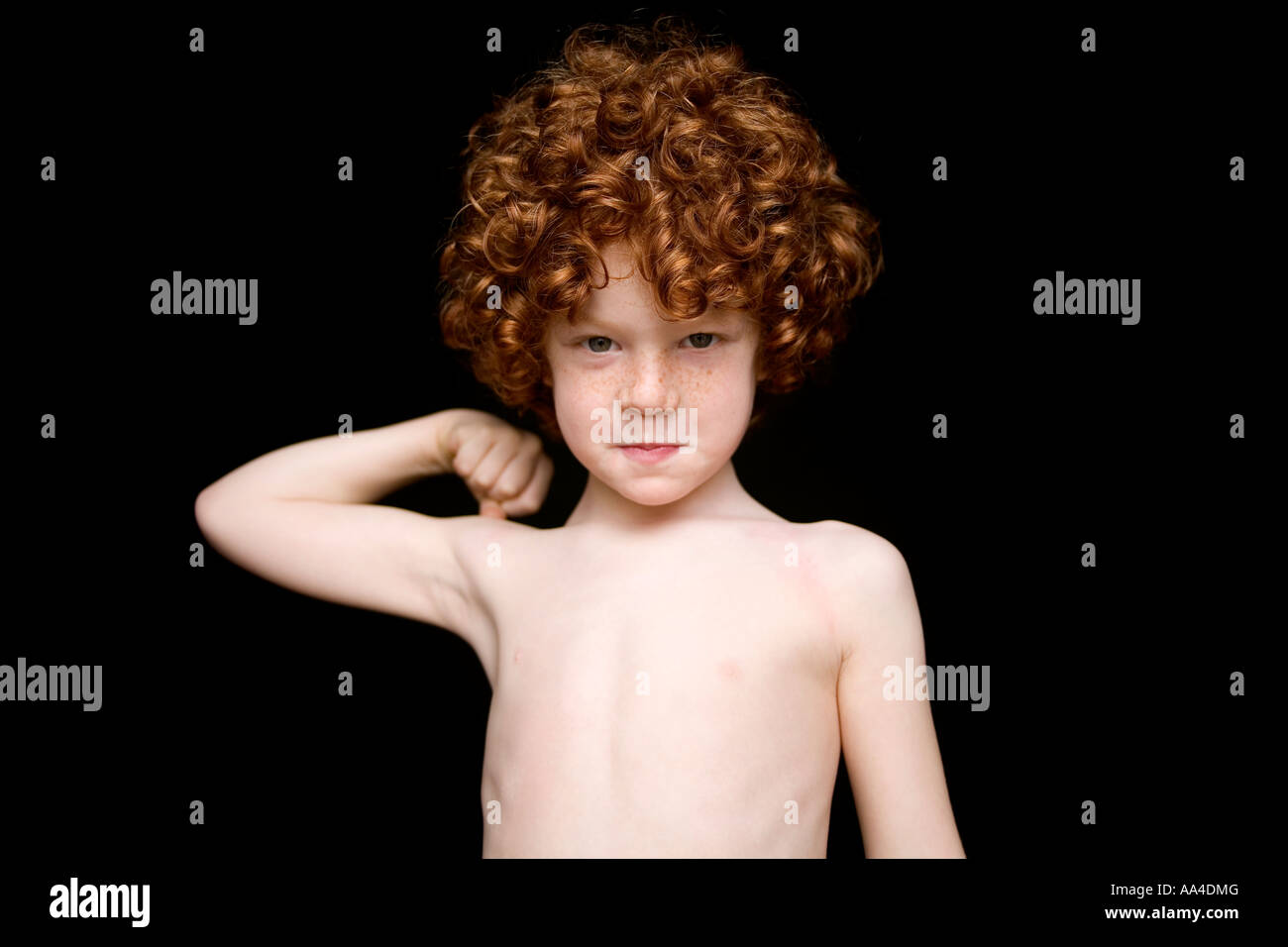 Young boy making muscles Stock Photo - Alamy