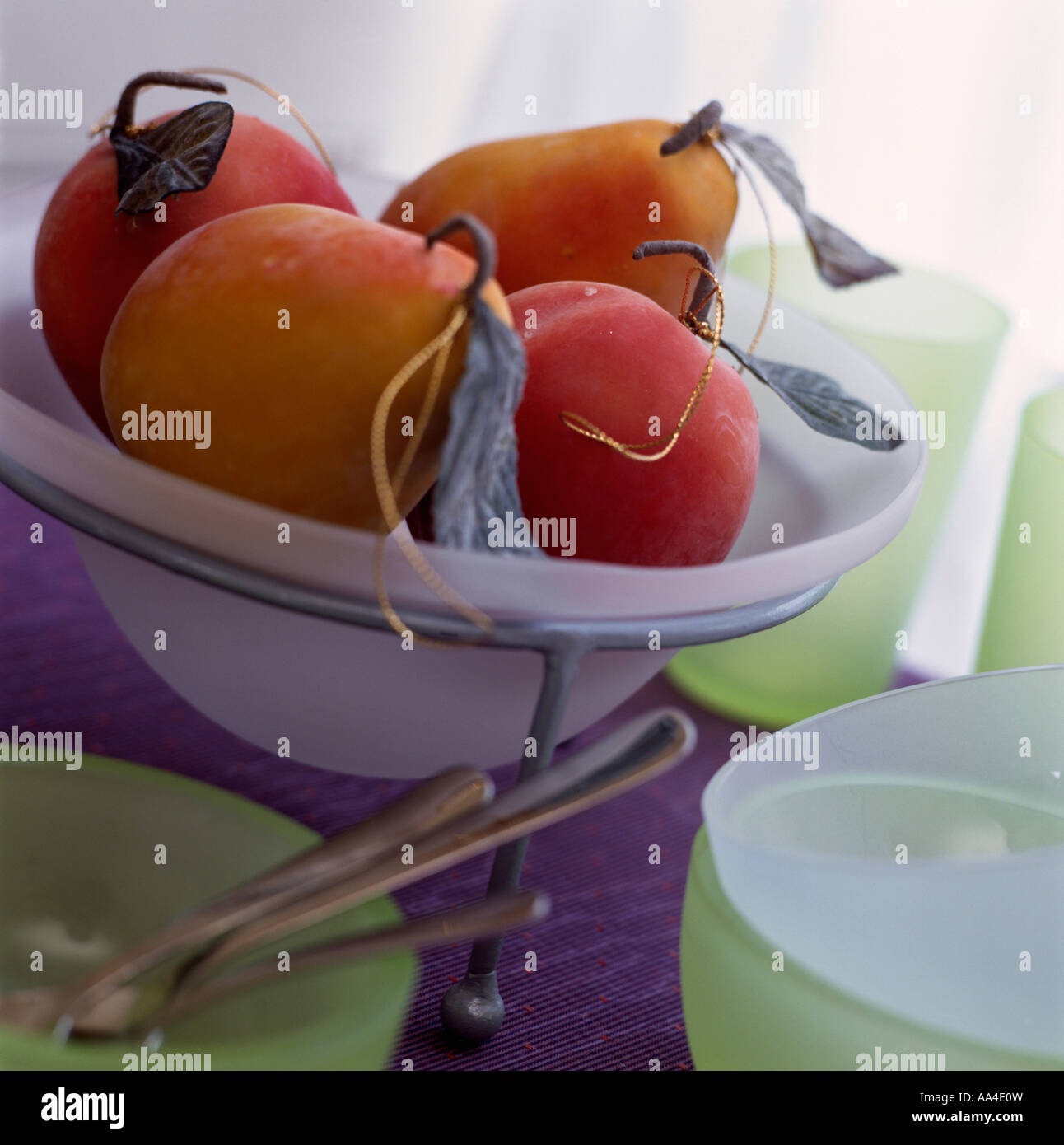 Close-up of red artificial pears in mauve bowl Stock Photo - Alamy