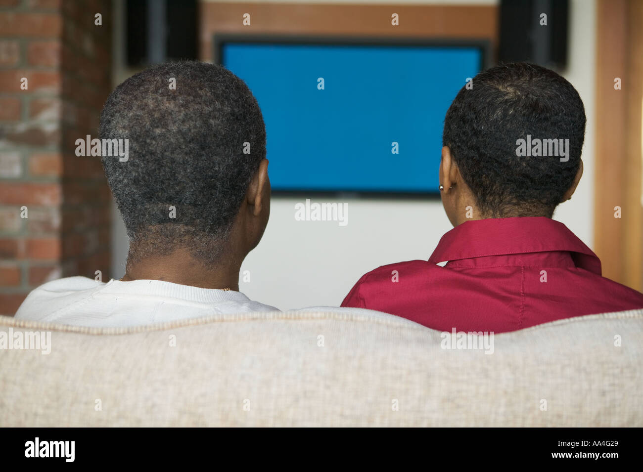 Seniors African Americans Watching plasma TV Stock Photo - Alamy