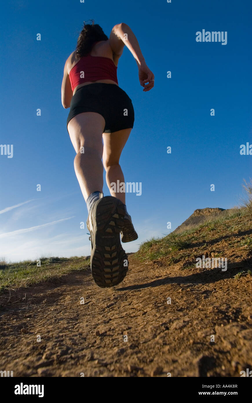 Action shot of a woman trail running Stock Photo - Alamy