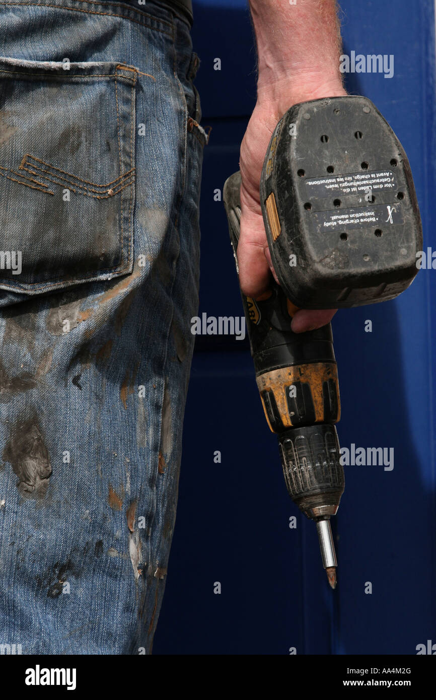 Tradesman holding a cordless power drill Stock Photo - Alamy