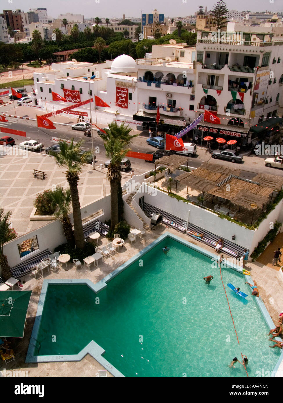 Thatch sunshades line beach holidaymakers cool off Monastir Beach ...