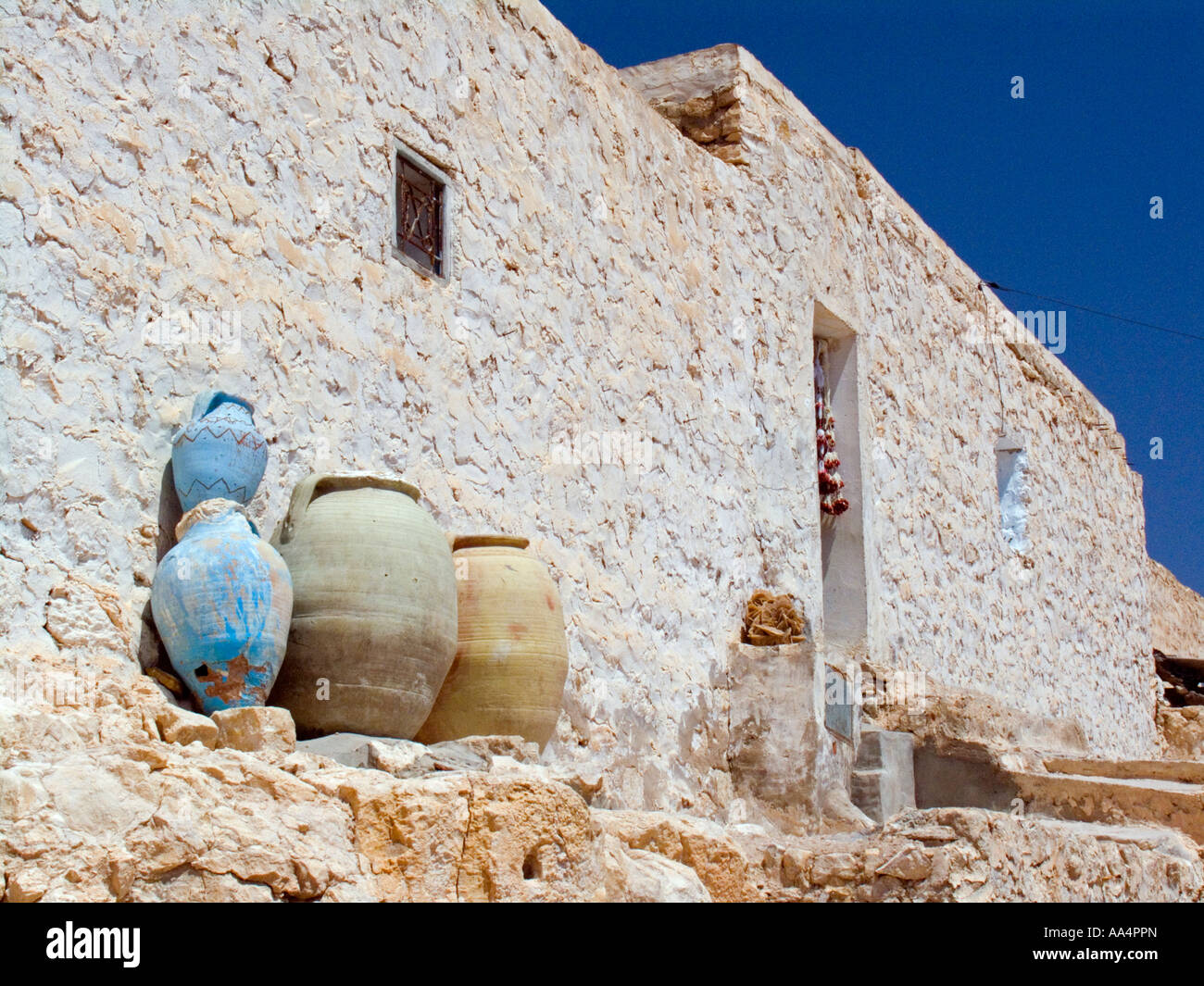 Large jars outside a traditional whitewash Berber home Tamezret Tunisia ...