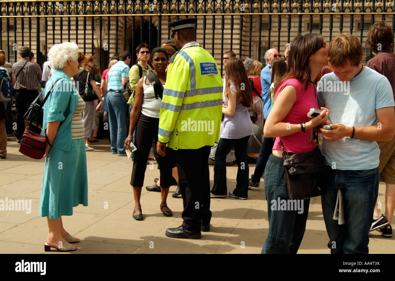 Police Community Support officer talks with visitor to London outside ...