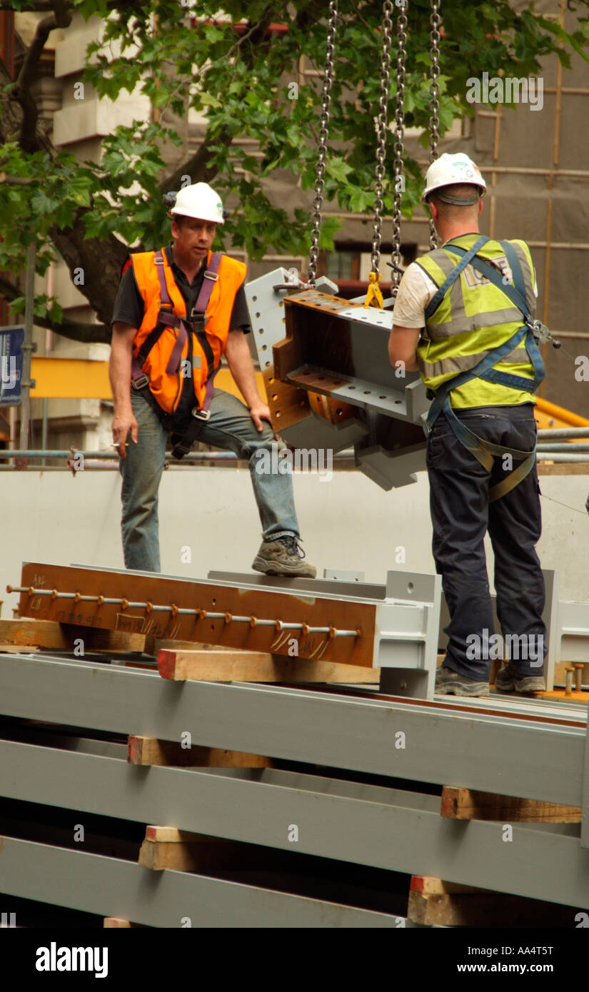 Construction workers and metal girders Building site employees Stock ...