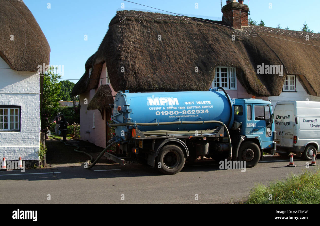 Septic and cesspit emptying service tanker lorry Outside a thatched ...