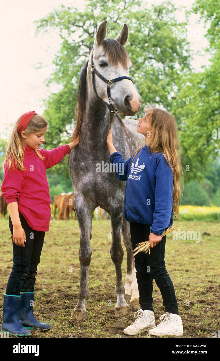Two girls standing horse hi-res stock photography and images - Alamy