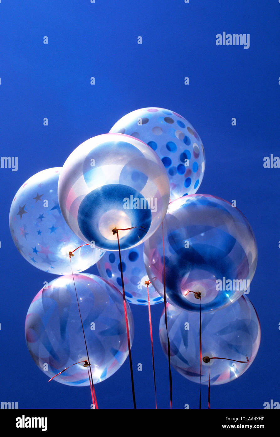 Tethered floating toy balloons against a blue sky. Nobody. Close-up ...
