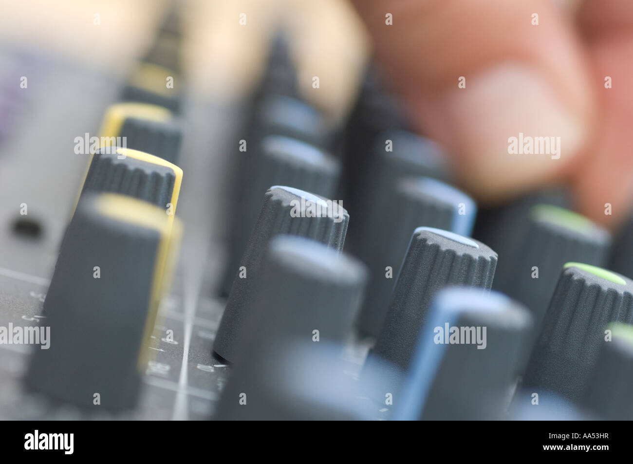 A mixing desk in a studio being adjusted by sound engineer. Picture by ...